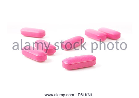 some pink painkiller pills on white background Stock Photo: 30234194 ...