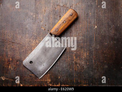 Vintage butcher meat cleaver. Dark wooden background. Top view. Copy ...