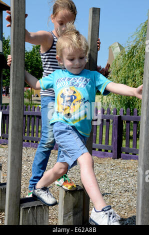 A girl on the obstacle course in adventure park, closeup cropped shot ...