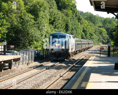Passenger train passing through a green field, Germany Stock Photo - Alamy