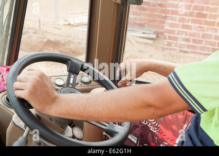 Front view of tractor with front end loader and trailer for excavator ...