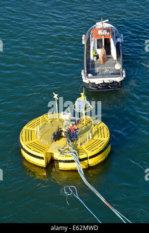 Aerial view motorboat & mooring crew release cruise ship hawsers fixed ...