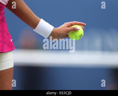 A hand holding a tennis ball on a white background Stock Photo - Alamy