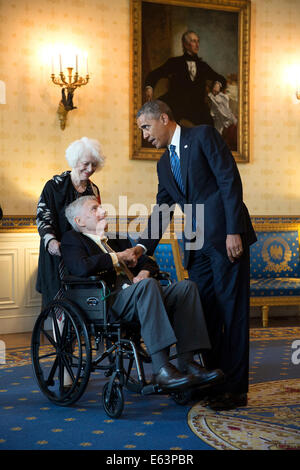 Former President Barack Obama greets the first group of visitors at the ...