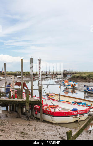 Boats at wooden jetties grounded at low tide at Morston, Norfolk in ...
