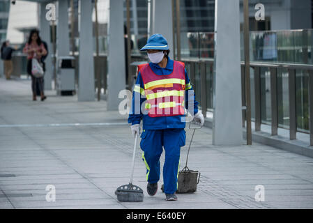 A woman wearing a reflective vest walks along 4th Line in Innisfil ...