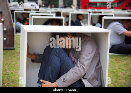 Men, women and children are squashed inside boxes to illustrate the ...