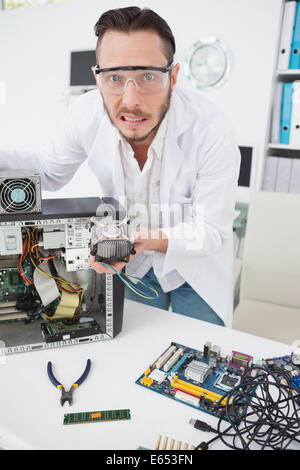 Confused computer engineer looking at wires Stock Photo - Alamy