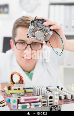 Smiling technician working on broken computer Stock Photo - Alamy
