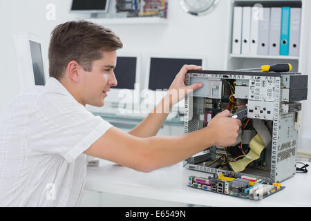 Young technician working on broken computer Stock Photo - Alamy