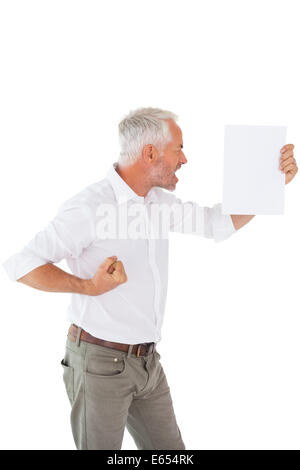 Angry man shouting at piece of paper Stock Photo - Alamy