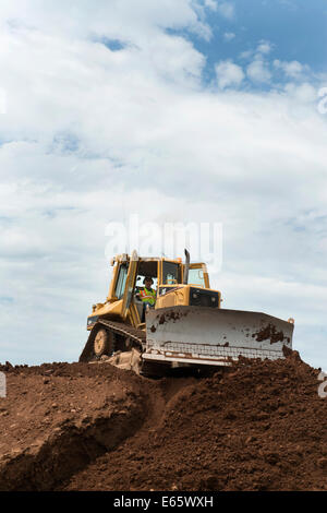 A bull dozer working on a pile of coal at the coal mine near Cadomin ...