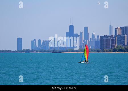 Hobie Cat with colorful sail in Lake Michigan with downtown Chicago in ...
