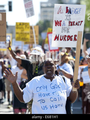 Protesters carrying signs and chant slogans against Elon Musk and ...