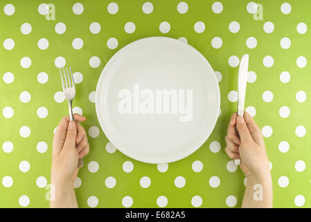 hands with kitchen flatware and healthy food in plate Stock Photo - Alamy