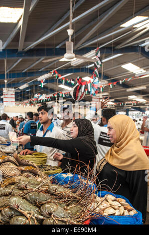 Fisherman with fish crab lobster shrimp in Deira fish market souk ...