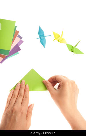 hands folding an origami bird Stock Photo - Alamy