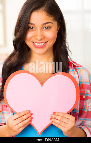 Young woman with paper heart on pink background. Valentine's Day ...
