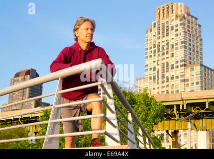 man leaning on railing Stock Photo - Alamy