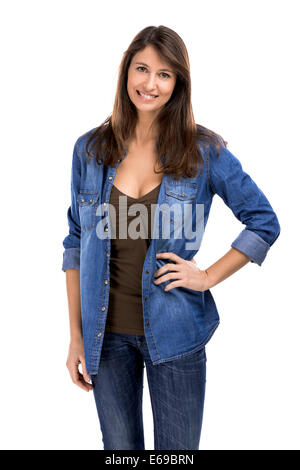 Beautiful brunette woman standing over isolated background laughing at ...