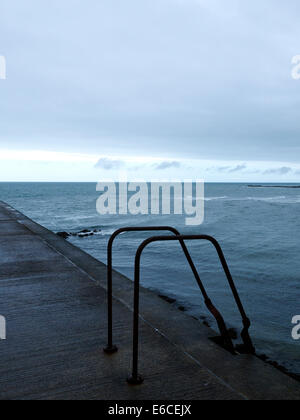 Detail of a stone jetty in the sea Stock Photo - Alamy