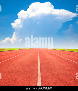 Red running track curve with blue sports field in right side and green ...