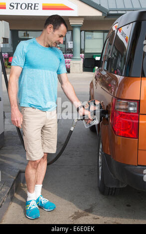 Senior Man Pumping Gas At Service Station Stock Photo - Alamy
