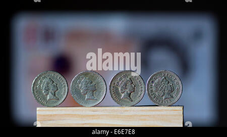 £1 British Stirling coins are pictured in front of a £10 British ...