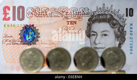 £1 British Stirling coins are pictured in front of a £10 British ...