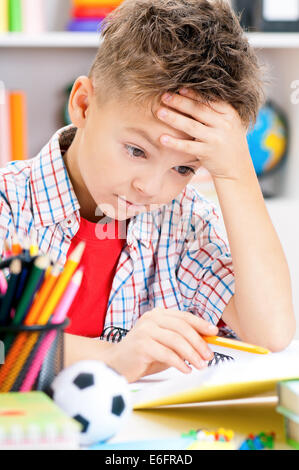 Sad angry boy have difficulties doing homework Stock Photo - Alamy