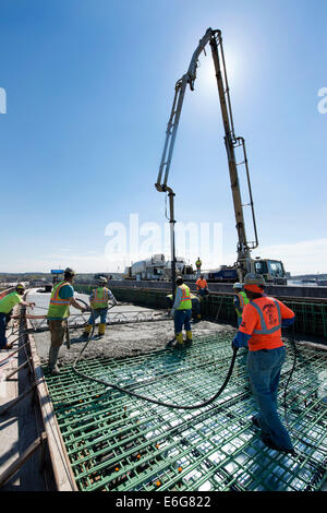 Mixer truck pouring concrete on a roadworks construction site in ...