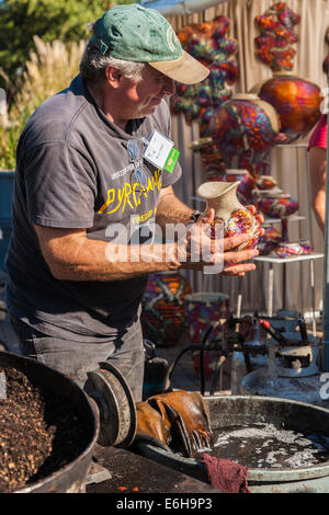 Bruce Odell demonstrates Raku firing of pottery at an art show in Ocean ...