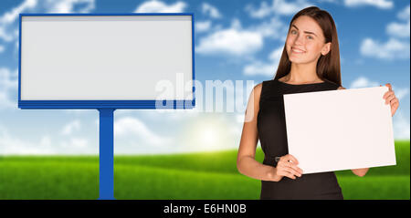 Businesswoman holding paper sheet. Large window as backdrop Stock Photo ...