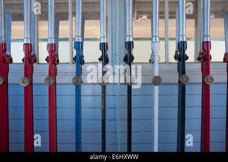 An old railway signal box with levers, clocks and signalman at ...