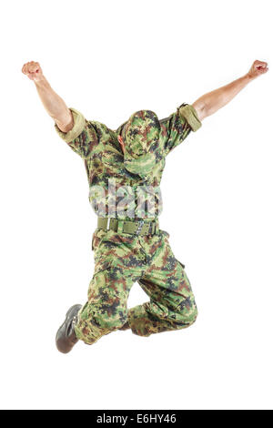 unknown soldier with hidden face in green camouflage uniform kicking ...