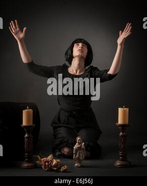 woman dressed in mourning beseeching God Stock Photo - Alamy