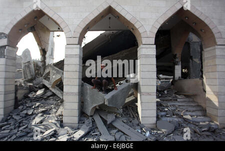 A Palestinian man inspects the rubble of the apartment of the Safadi ...