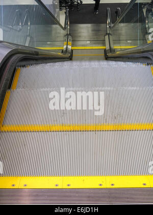 Empty escalators stairway with a yellow stripes Stock Photo - Alamy