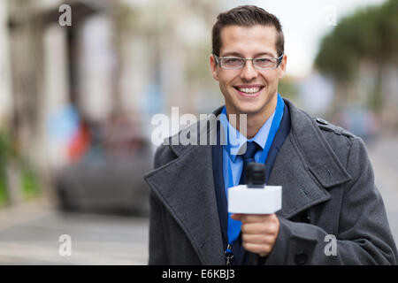 Successful handsome male news reporter wearing light grey suit working ...