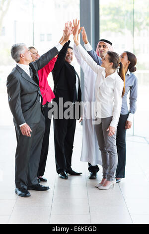 happy business team giving high five in office Stock Photo - Alamy