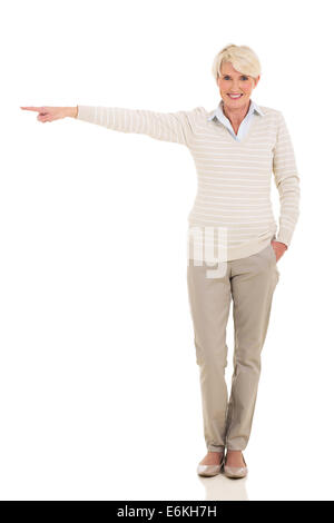 Excited beautiful girl smiling and pointing fingers aside isolated over ...