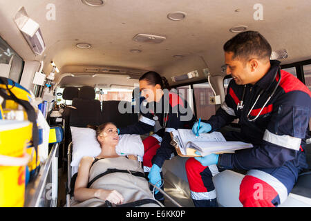 friendly paramedics talking to patient on stretcher Stock Photo - Alamy