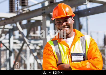 African electrical engineer with arms crossed in electricity power ...
