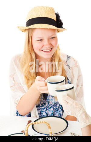 Teenage girl serving tea at a formal tea party. Isolated on white Stock ...