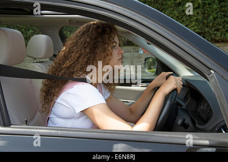 Bad posture and driving position young female driver leaning over the ...