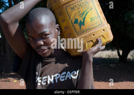 One of the inhabitants of Mukuni Village bringing a water jerican. He's ...