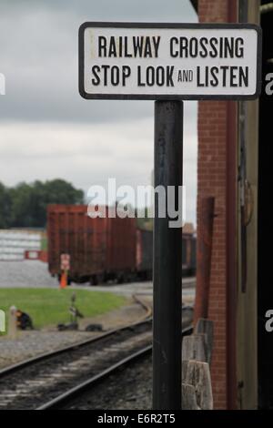 Railroad crossing stop look and listen sign white with black letters ...