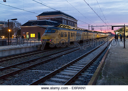 Dutch NS "sprinter" commuter train crossing a bridge in Amsterdam Stock ...