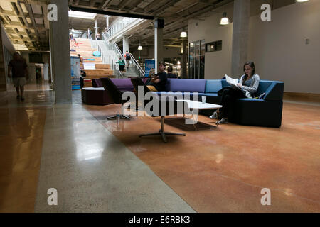 Students relaxing, walking in hallways of new campus of Austin ...