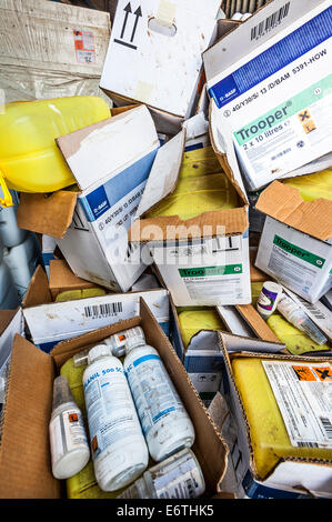 A pile of empty pesticide boxes containers and cans piled up in the ...